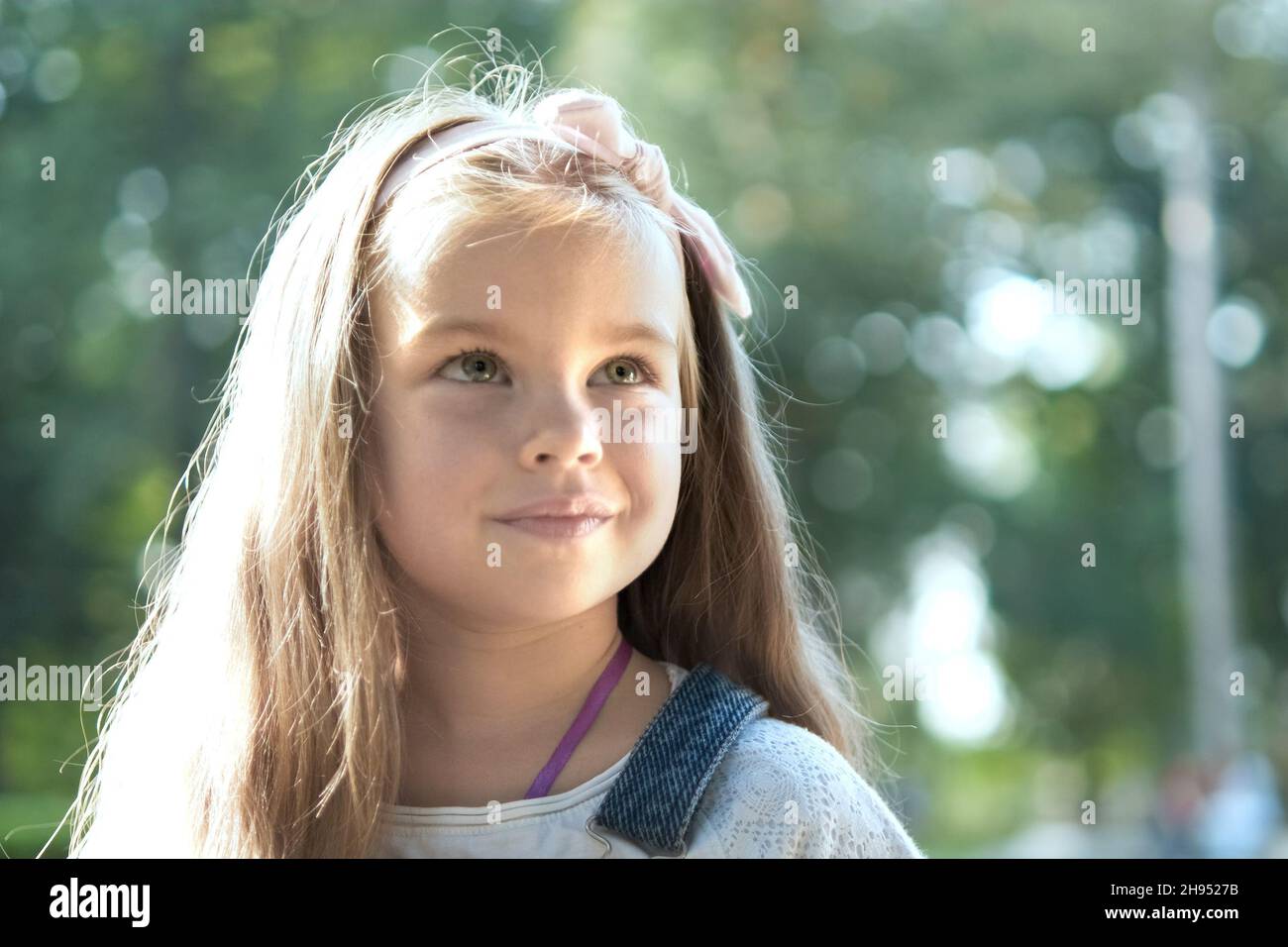 Portrait of pretty child girl standing outdoors in summer park Stock ...