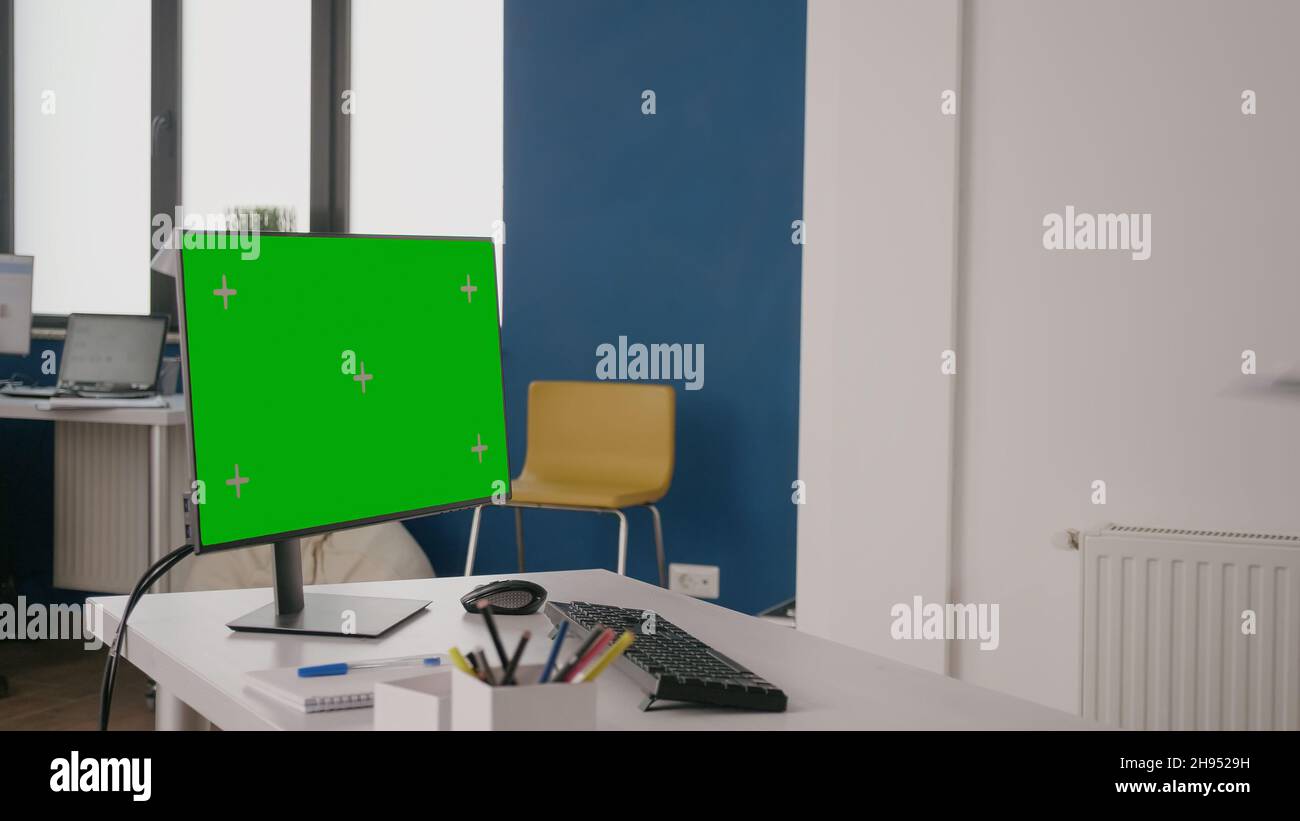 Company worker using green screen on computer at desk. Woman working ...