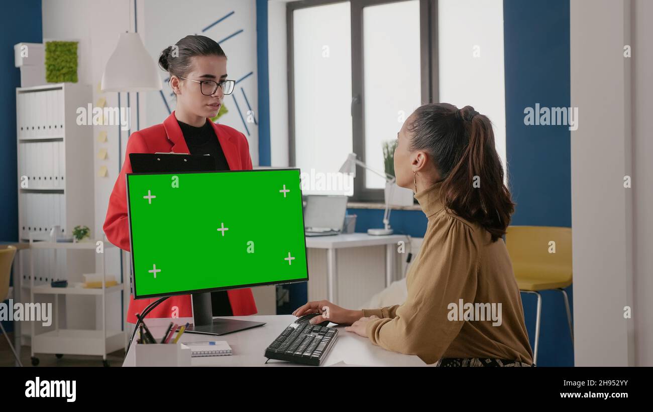 Women doing teamwork with green screen on computer, colleagues using ...
