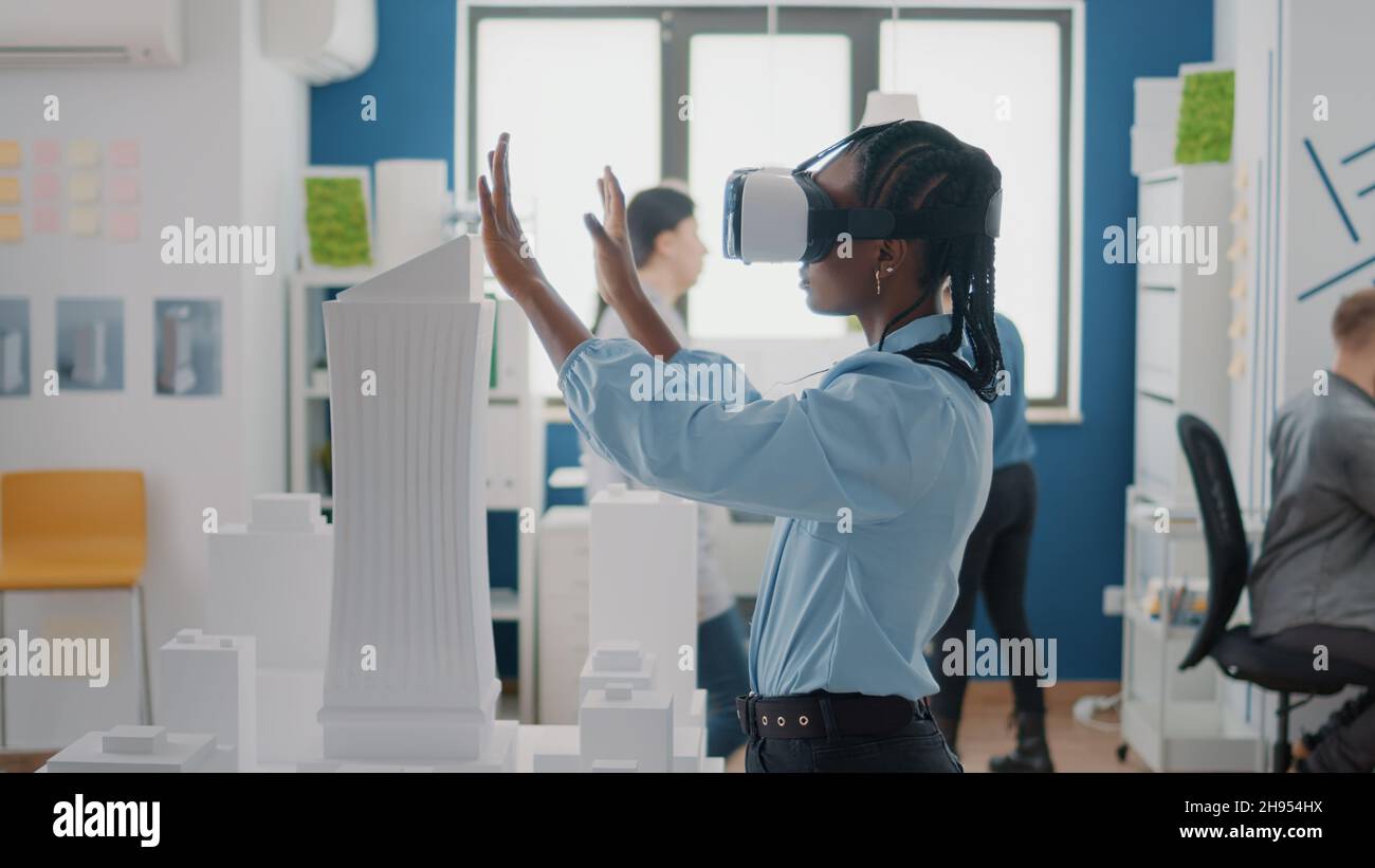 Close up of engineer working with vr glasses to plan building model and ...