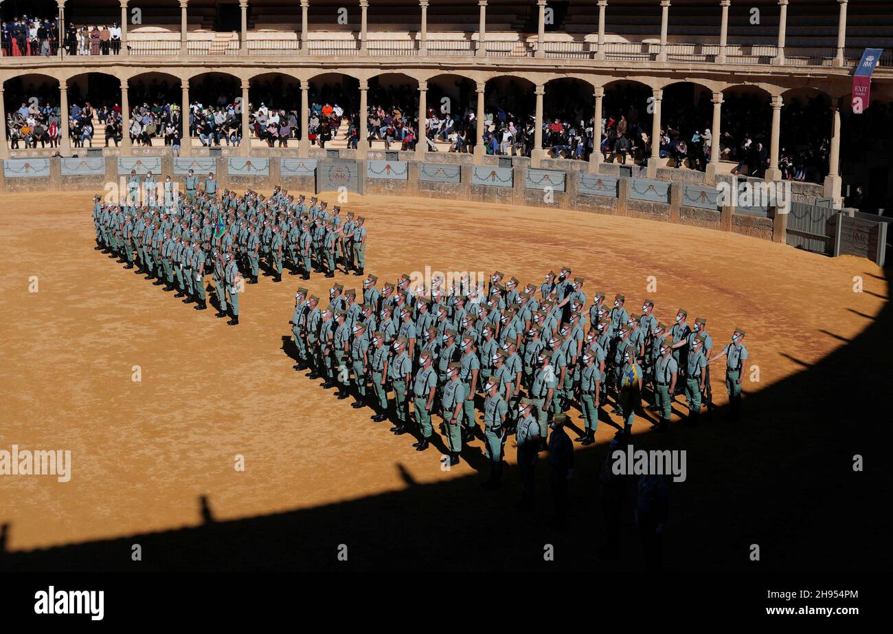 Spanish legionnaires, wearing protective face masks, stand at attention ...
