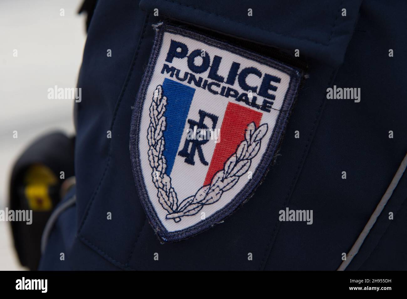 A close-up of the Municipal Police crest on a police officer's uniform ...