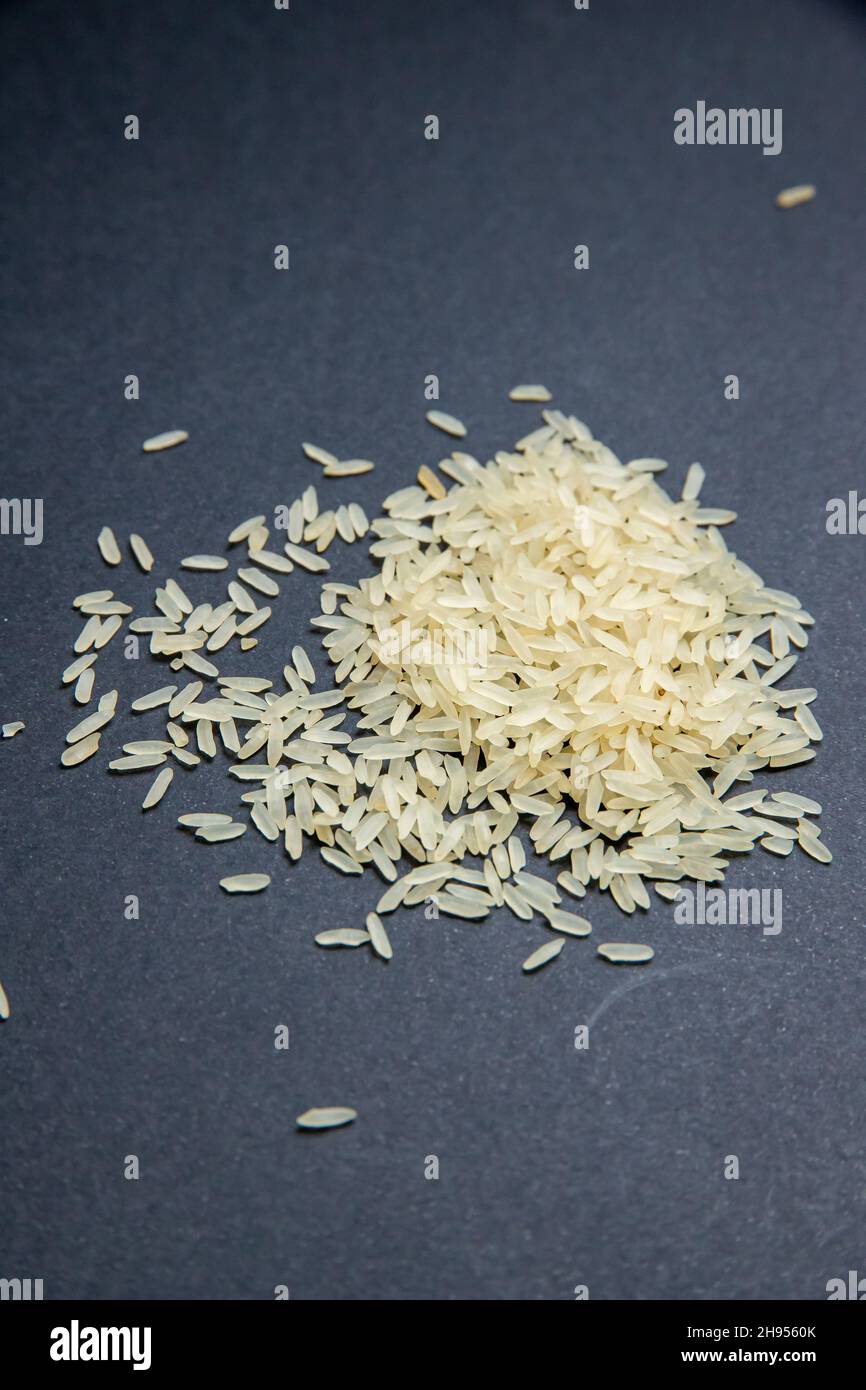 Pile of rice isolated on dark background Stock Photo - Alamy