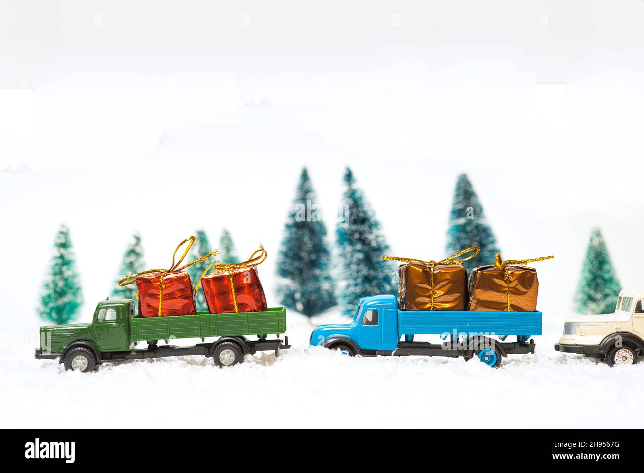 transportation of a Christmas presents with trucks in a snowy landscape ...
