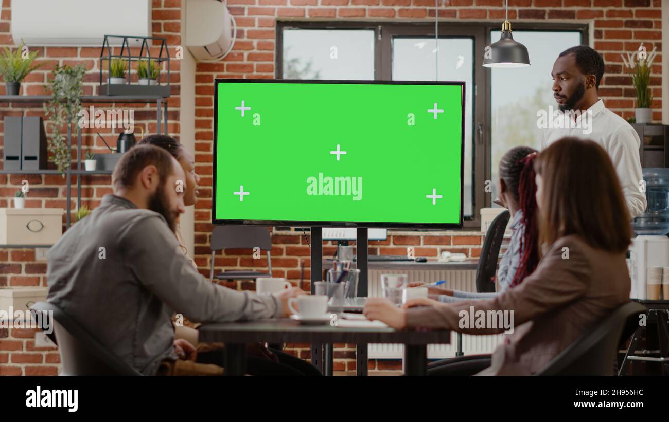 Business man presenting monitor with green screen at meeting with ...