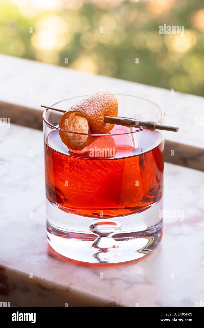 Negroni Bitter Cocktail Drink with Orange Twist over Ice in Rocks Glass ...