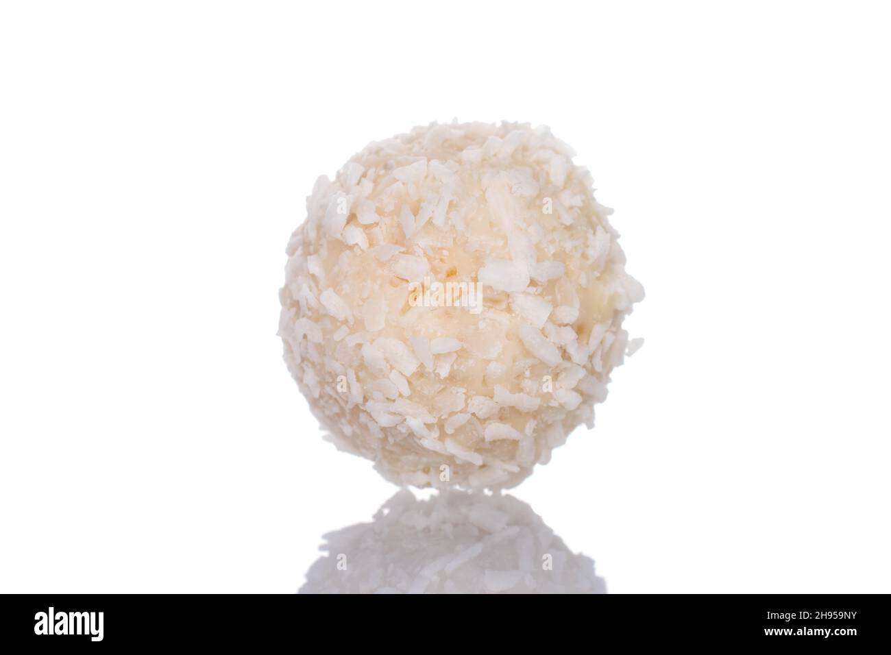One sweet tasty candy with coconut flakes, close-up, isolated on white ...