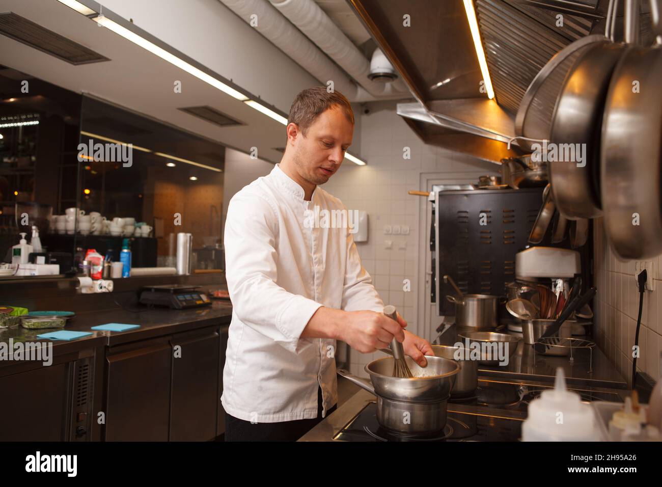 Male chef melting butter, cooking at restaurant kitchen, copy space ...