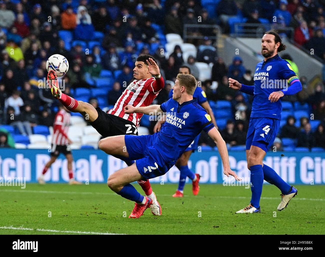 Cardiff, Wales, 4th December 2021. Mark McGuinness of Cardiff City puts ...