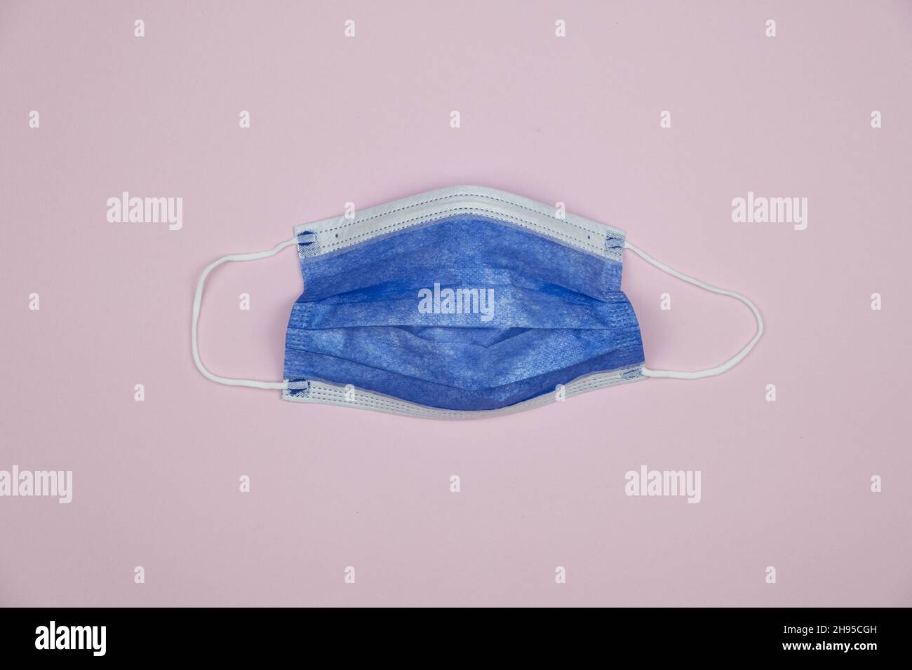 Blue face mask isolated on pastel background with space for text Stock ...