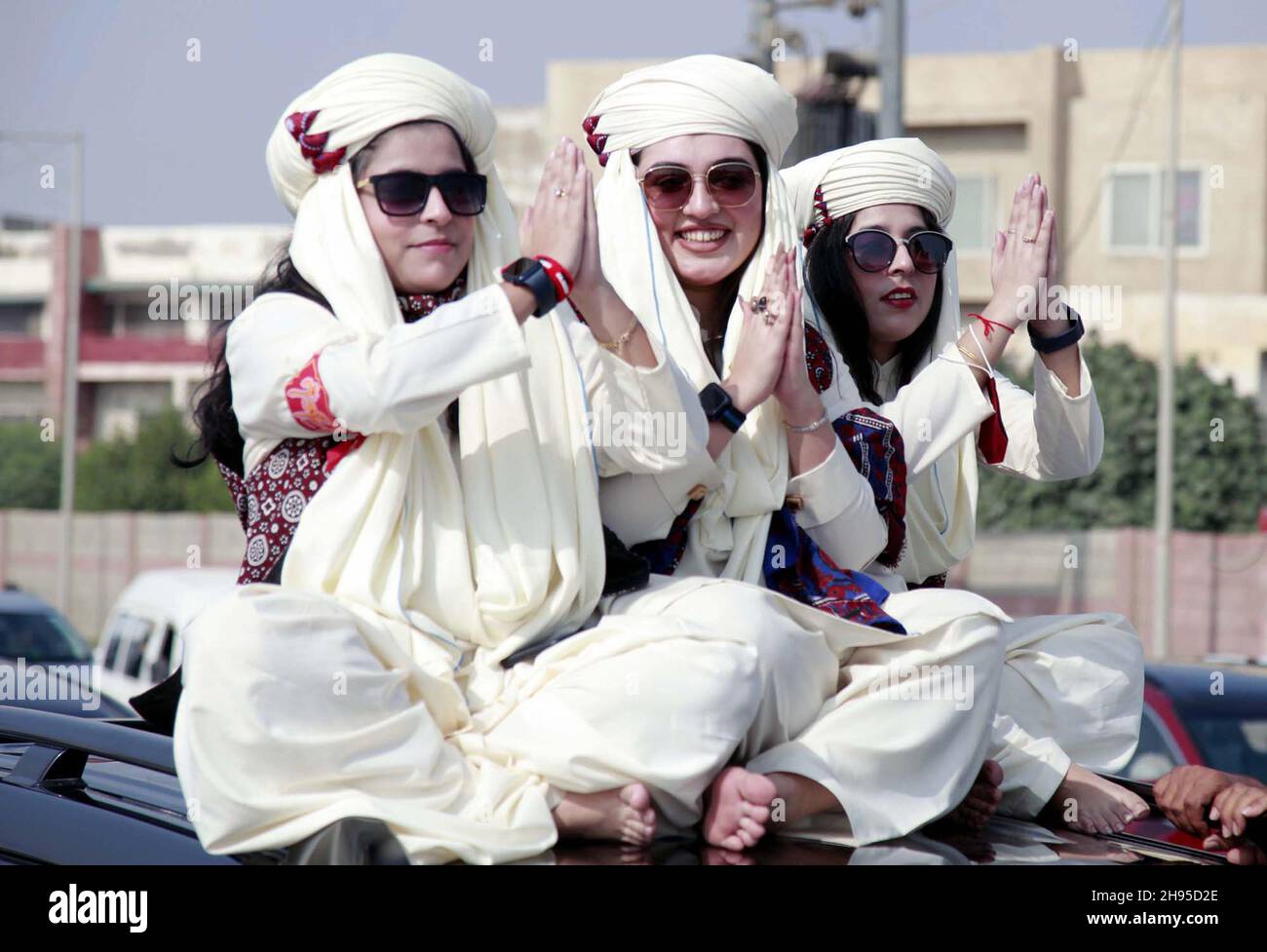 People are wearing Sindh traditional dresses as they holding ...