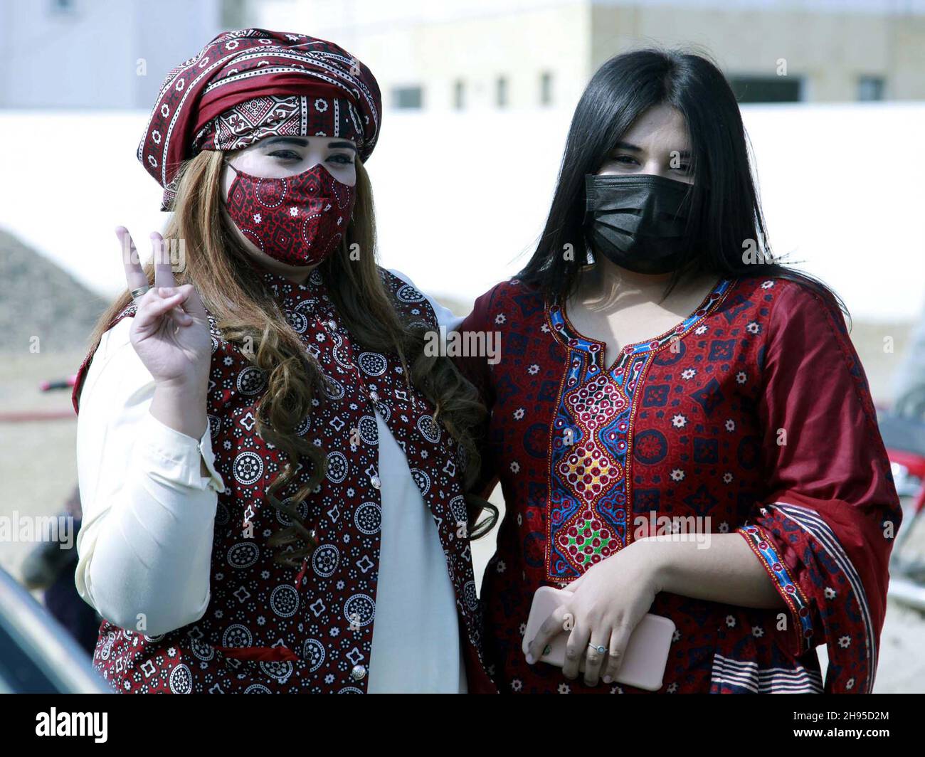 People are wearing Sindh traditional dresses as they holding ...