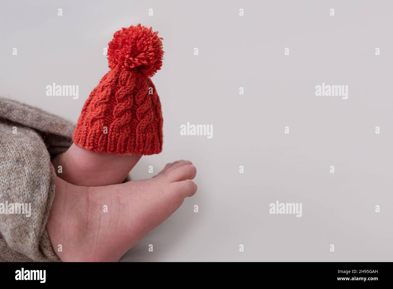 newborn baby feet with Christmas decorations. Funny cute small red ...