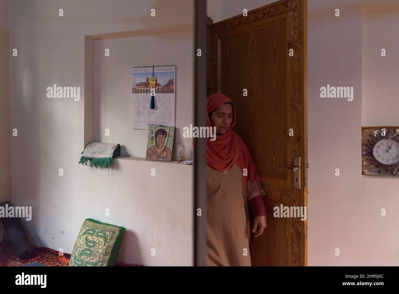 Photograph of Mohammad Ramzan is seen reflected in a mirror as Jameela ...