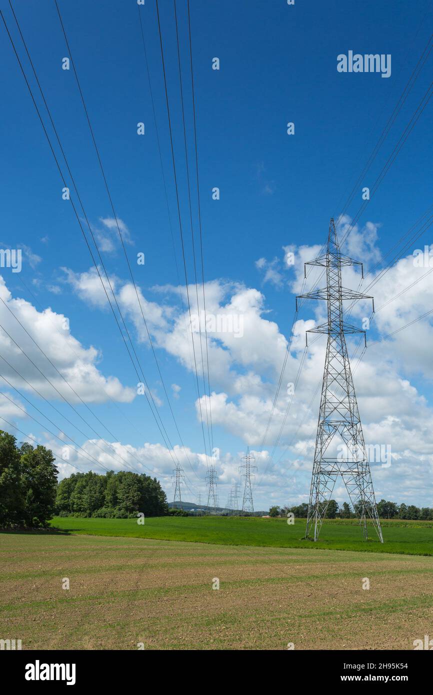 Electric pylons with electrical wires installed in a field and going to ...