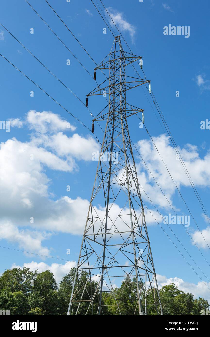 Electric pylons with wires on the a blue sky and white clouds ...