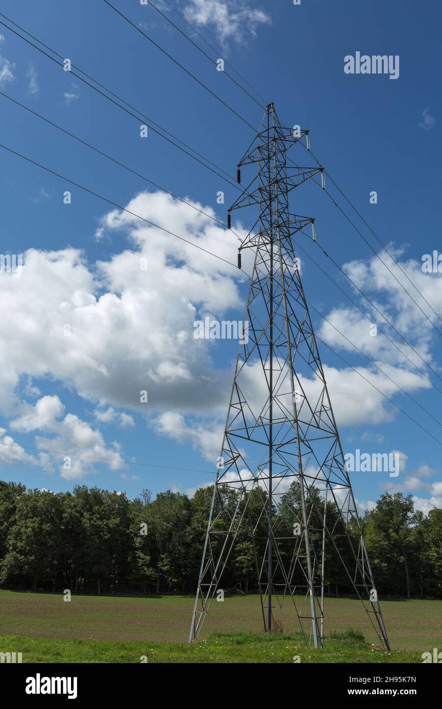Electric pylons with wires on the a blue sky and white clouds ...