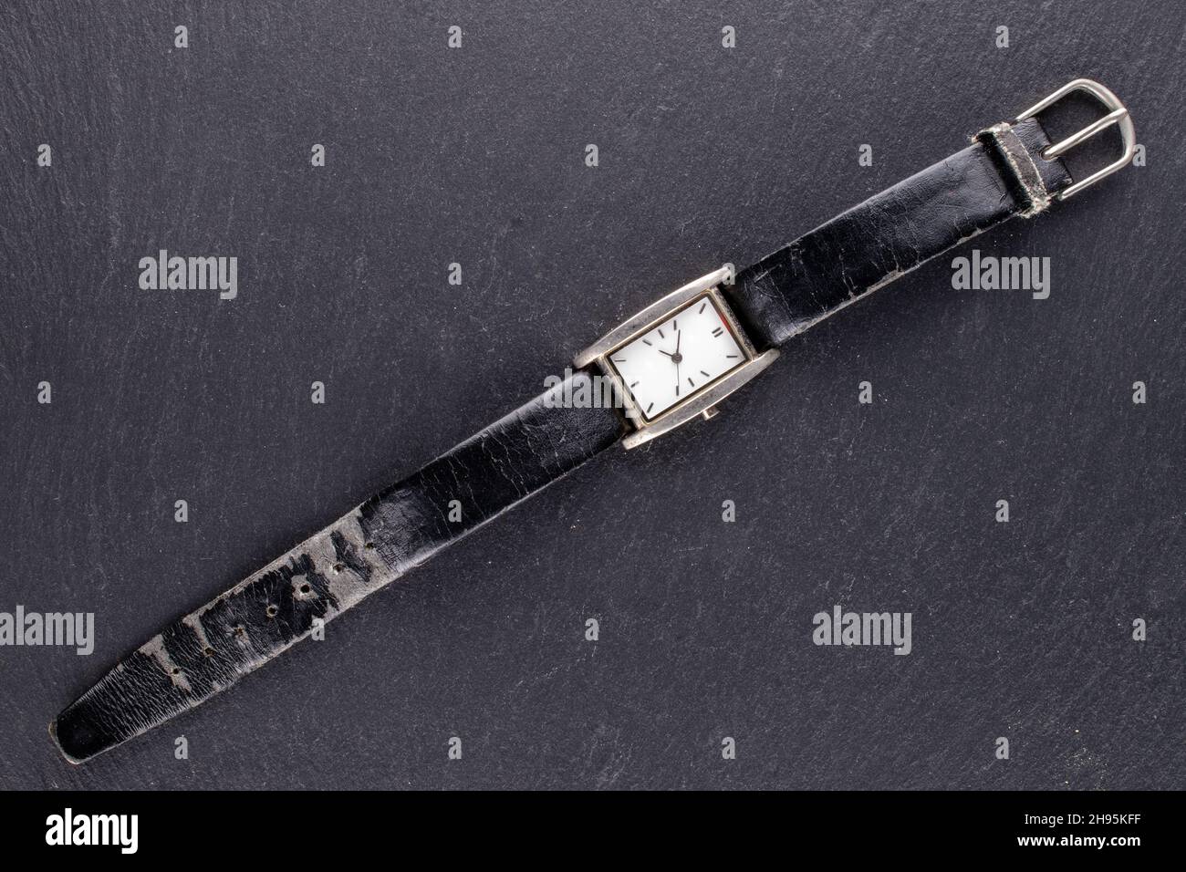 One wrist watch on a slate stone, close-up, top view Stock Photo - Alamy