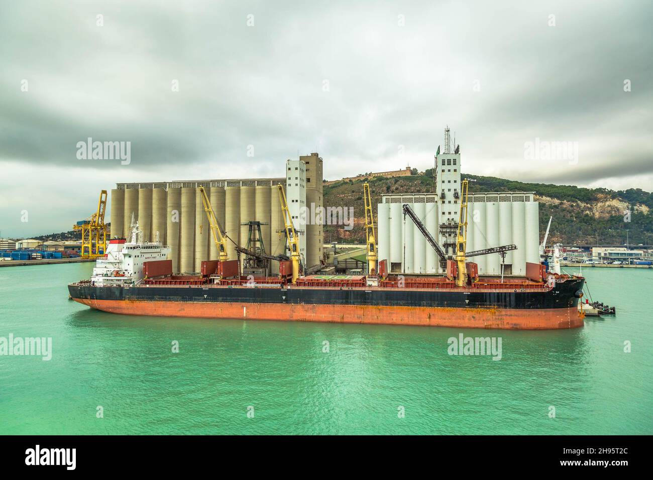 Docked cargo ship with silos in the back Stock Photo - Alamy