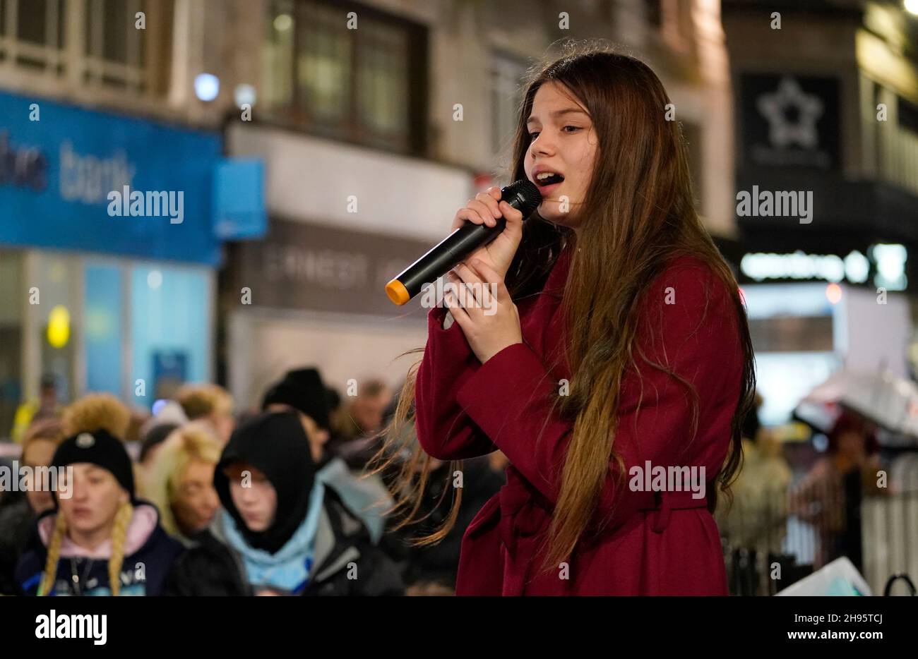 12 year old Astrid Smith sings during a vigil in Liverpool city centre ...