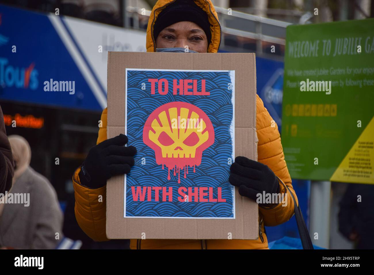 London, UK. 04th Dec, 2021. An activist holds an anti-Shell placard ...