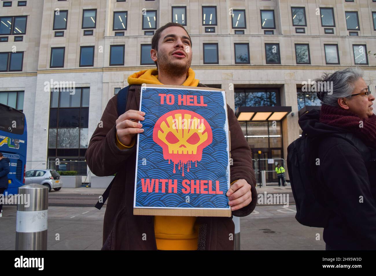 An activist holds an anti-Shell placard during the demonstration ...