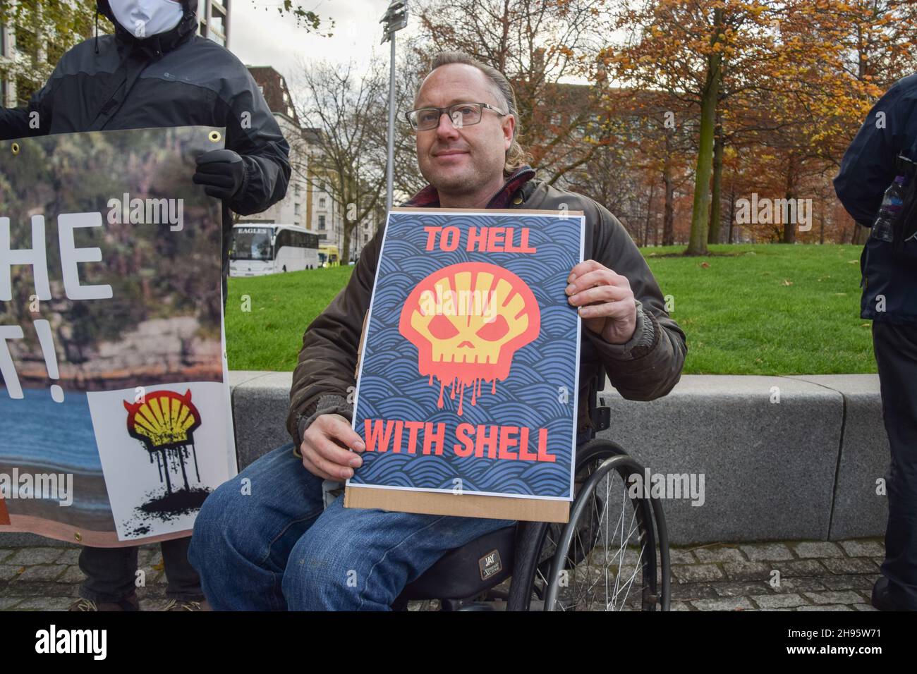 London, UK. 04th Dec, 2021. An activist holds an anti-Shell placard ...