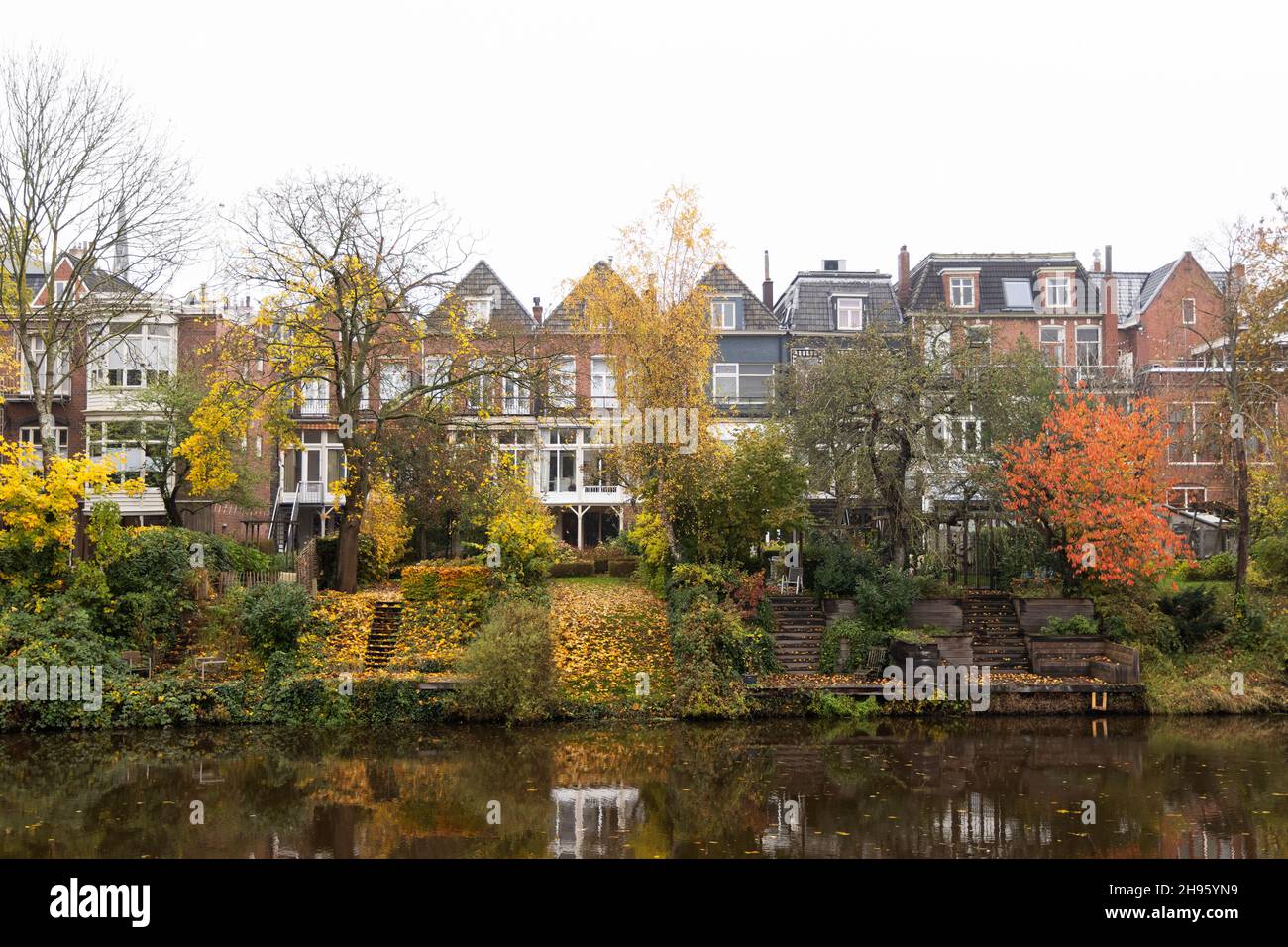 Houses and trees in fall colors line the Verbindingskanaal along ...
