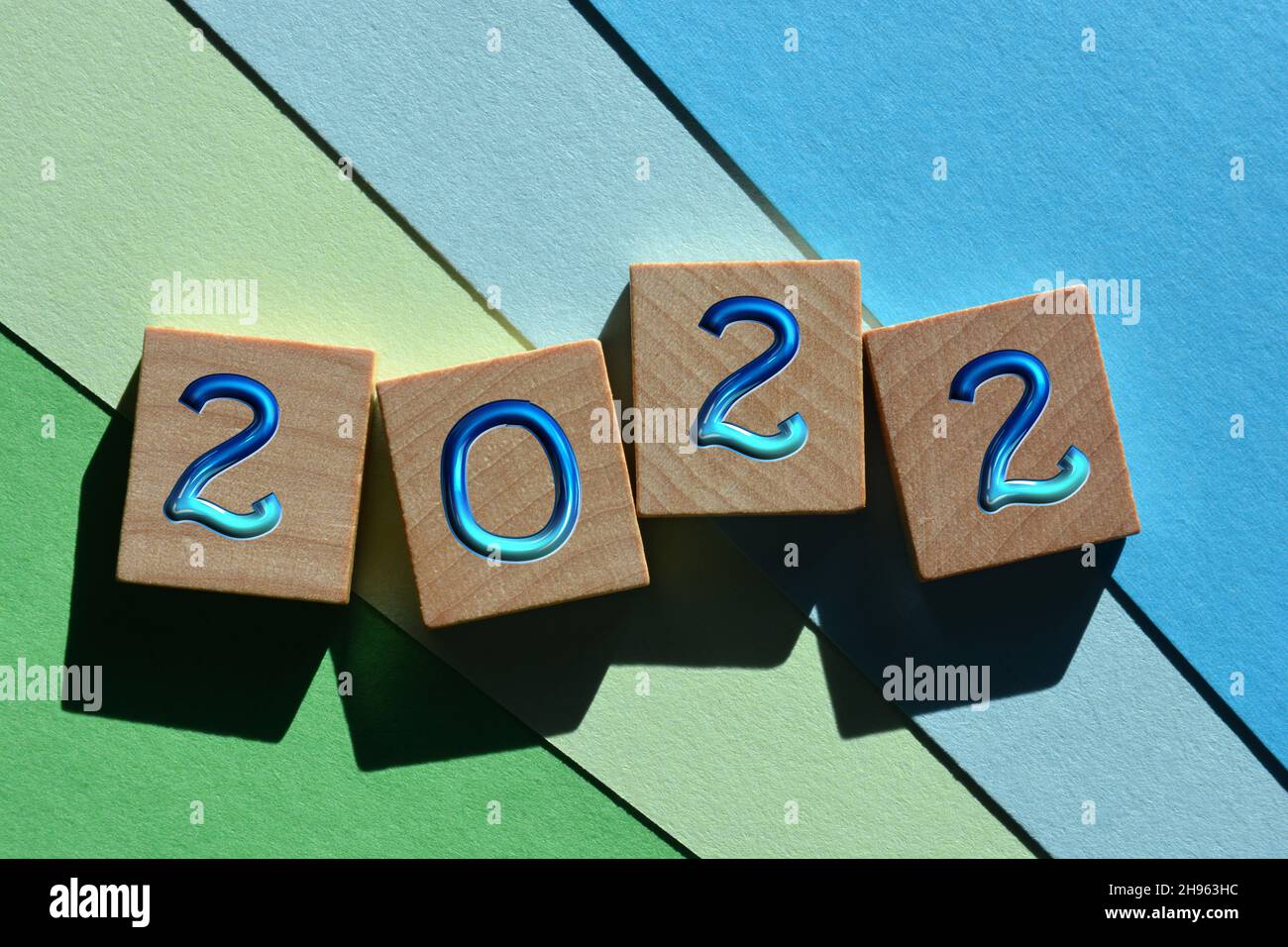 2022, Year date in wooden alphabet letters on blue and green background ...