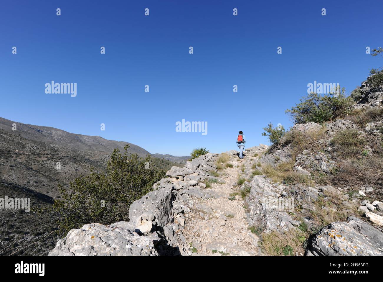 Woman hiking on ancient Mozarabic trail, originally a Moorish mule ...