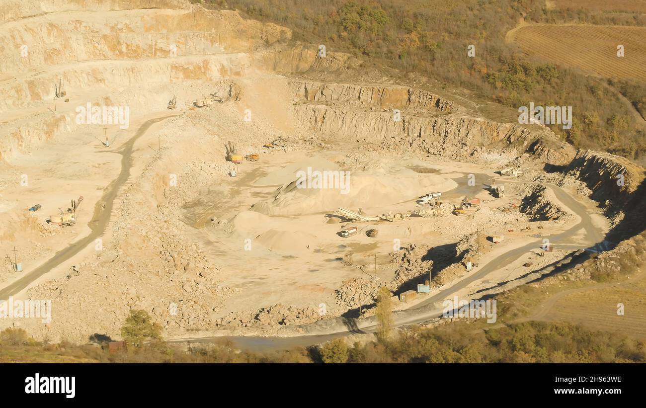 Top view of working quarry. Sand pit with escalators and buldozeri in ...