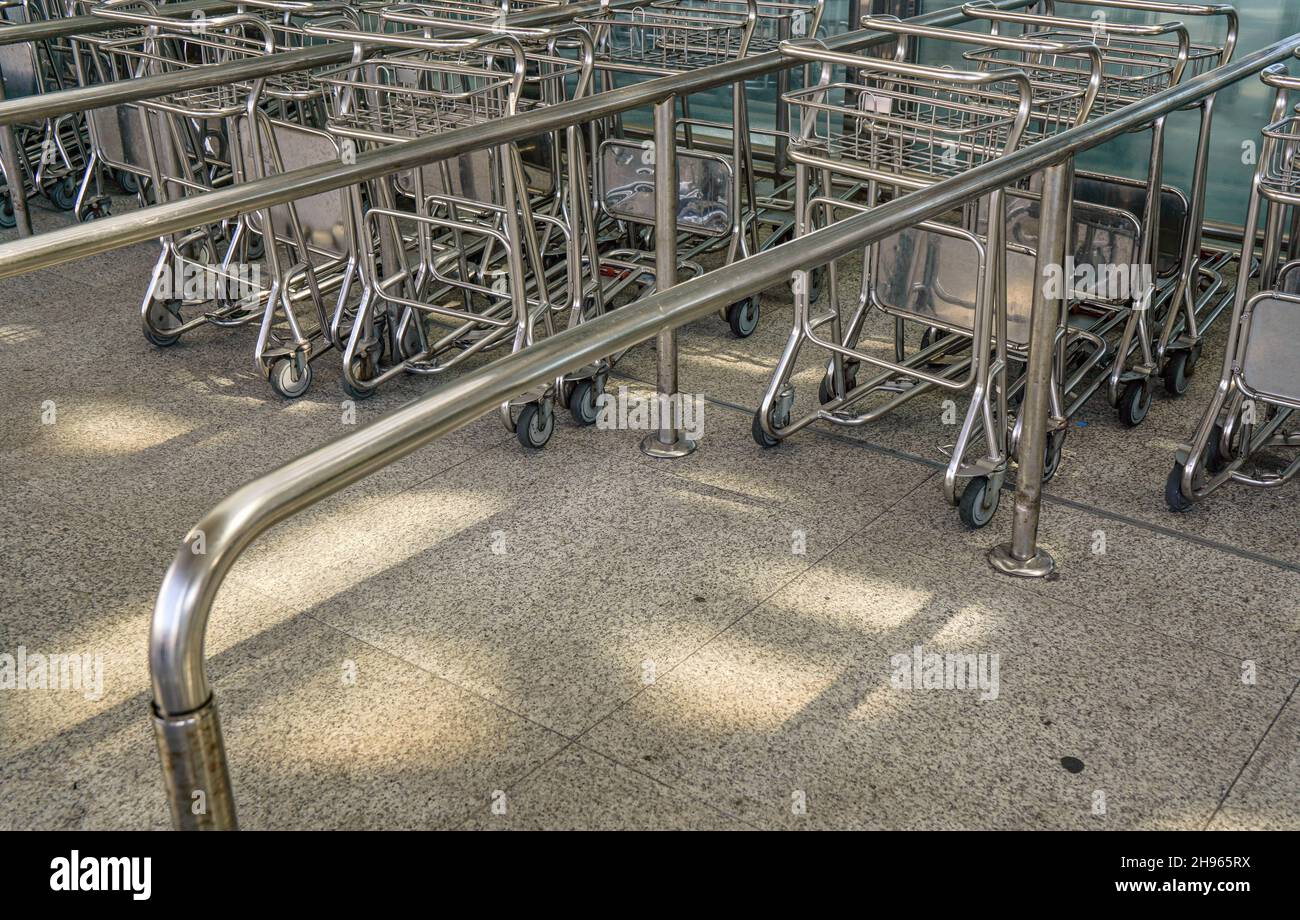 Metal airport luggage carts parked together near entrance Stock Photo ...