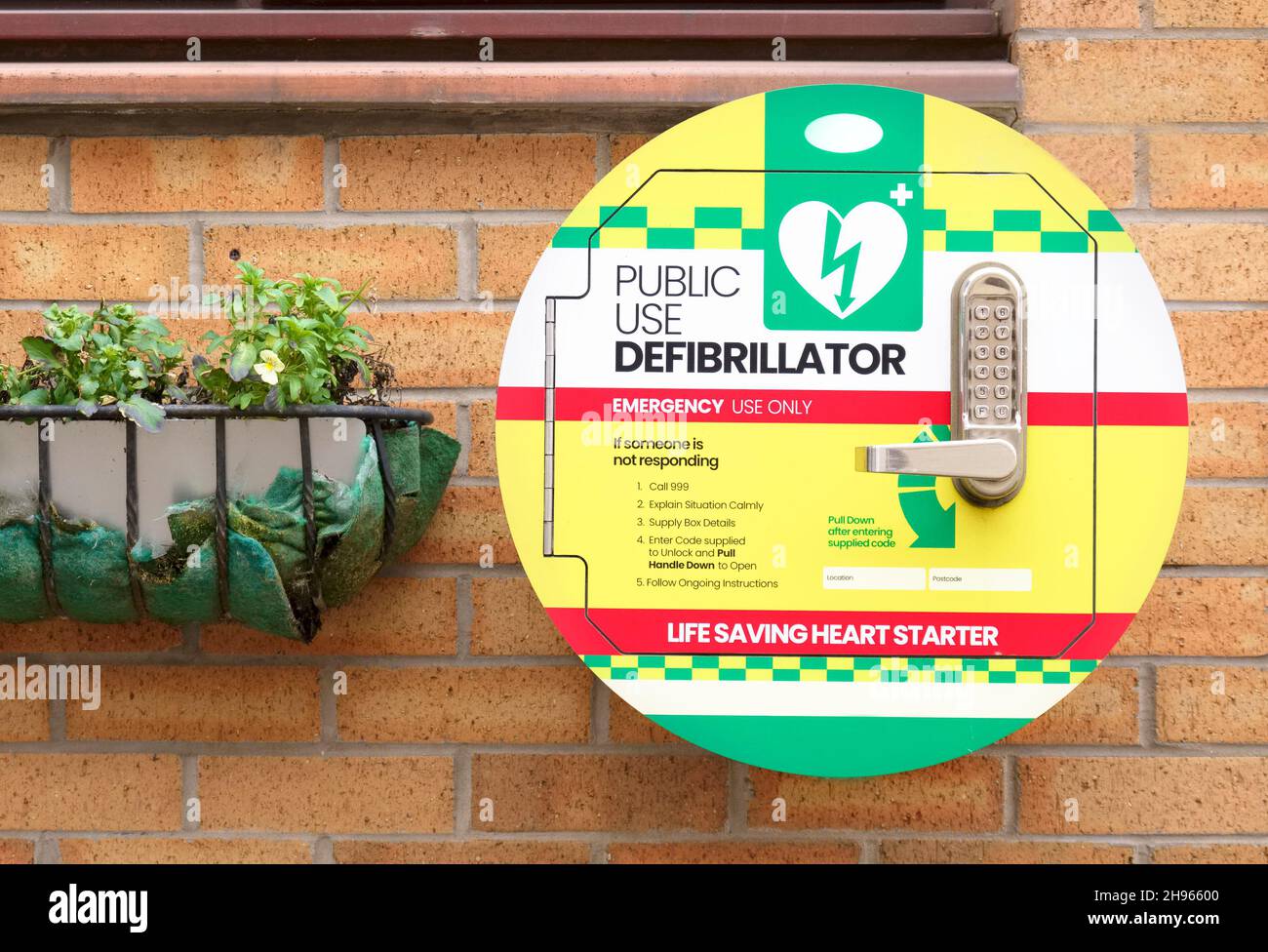 Defibrillator AED on wall in public space for emergency heart ...