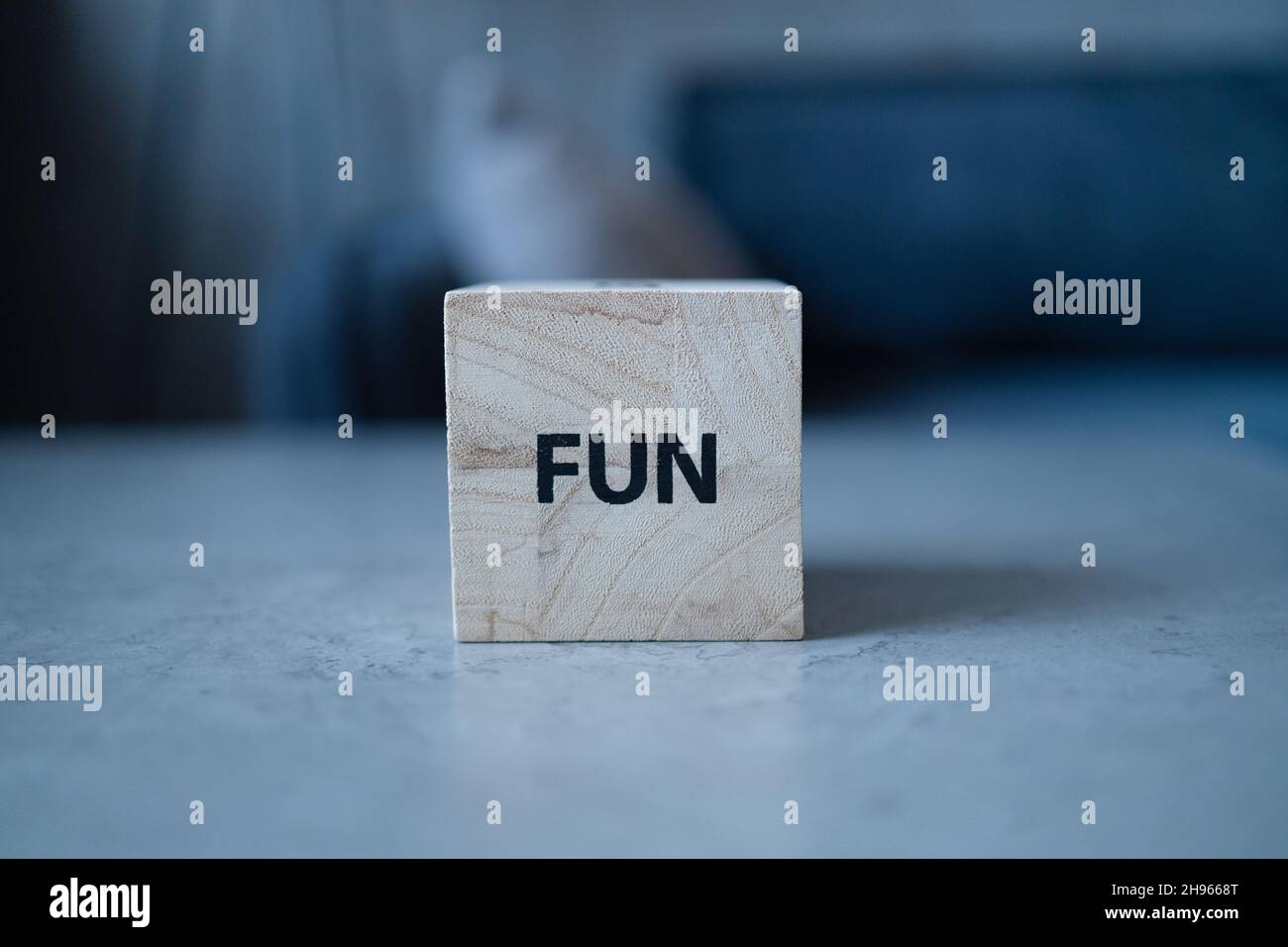 Fun stamp letters text on wood blocks on concrete table background ...