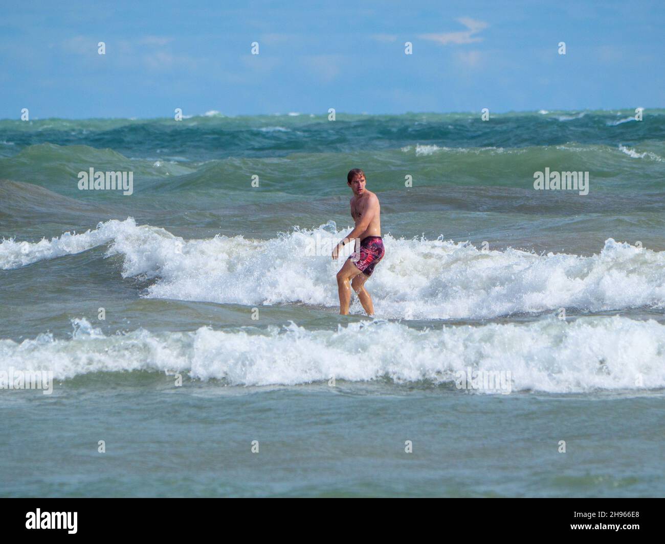 A surfer catches a wave at Chicago's Montrose Beach Stock Photo - Alamy