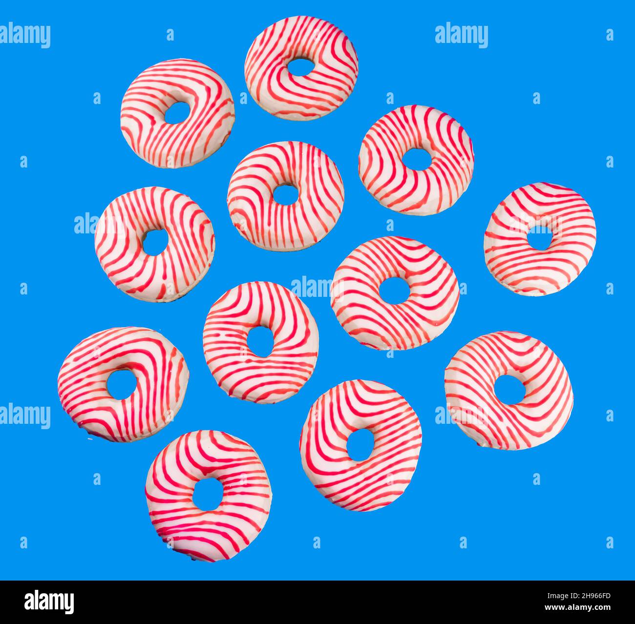 Flat lay donuts on a blue background. Top view. Pink and white donuts ...