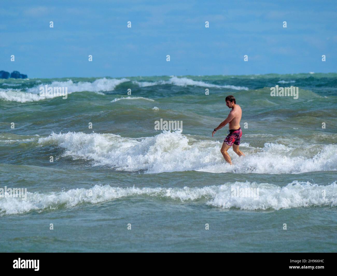 A surfer catches a wave at Chicago's Montrose Beach Stock Photo - Alamy