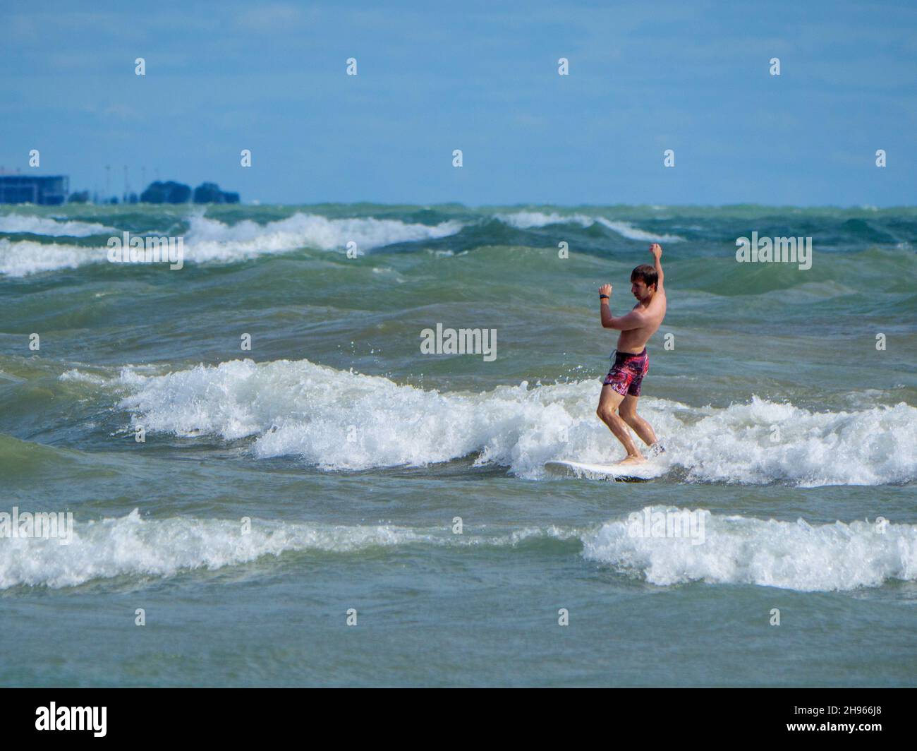 A surfer catches a wave at Chicago's Montrose Beach Stock Photo - Alamy