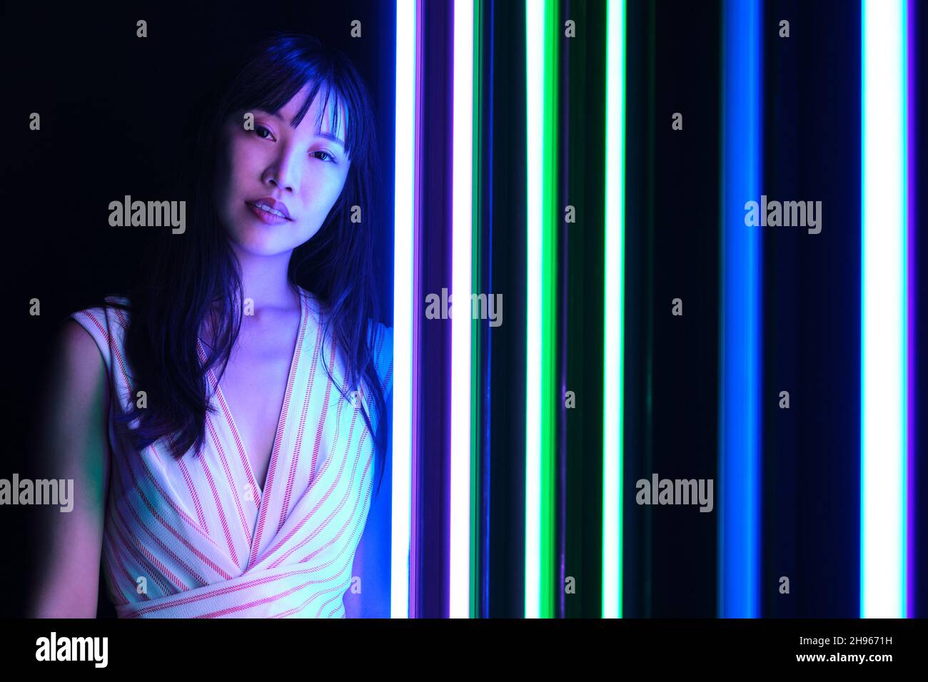 Young asian woman pose with colorful bright neon lights in studio Stock ...