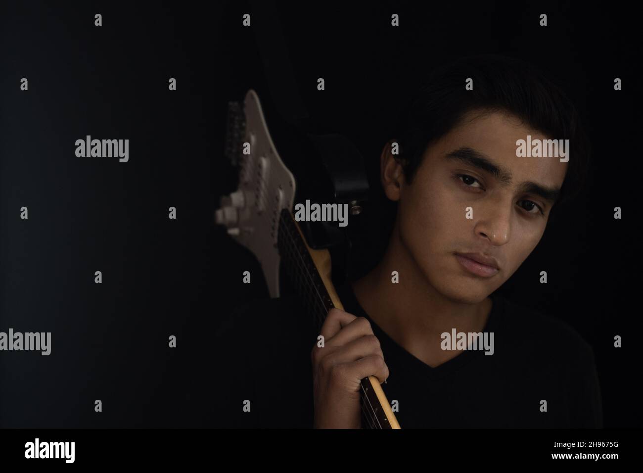 young and attractive latin rock musician posing with his electric ...