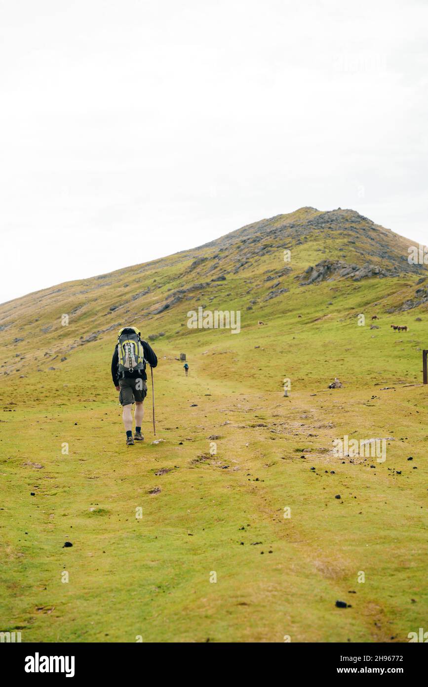Lone pilgrim walking the Camino de Santiago through the Pyrenees ...