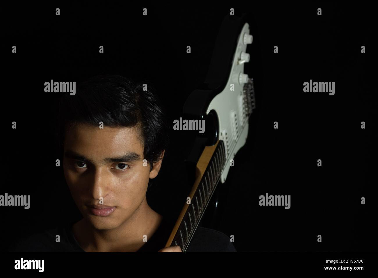 young and attractive latin rock musician posing with his electric ...