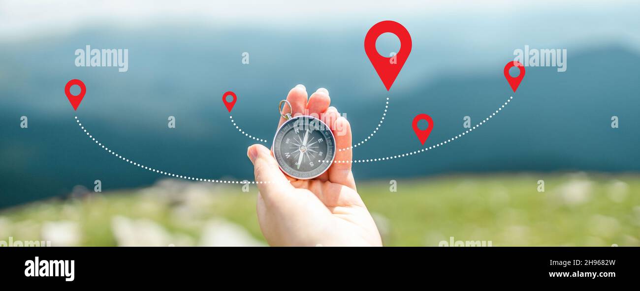 Traveler holding compass in hand for searching direction outdoor ...