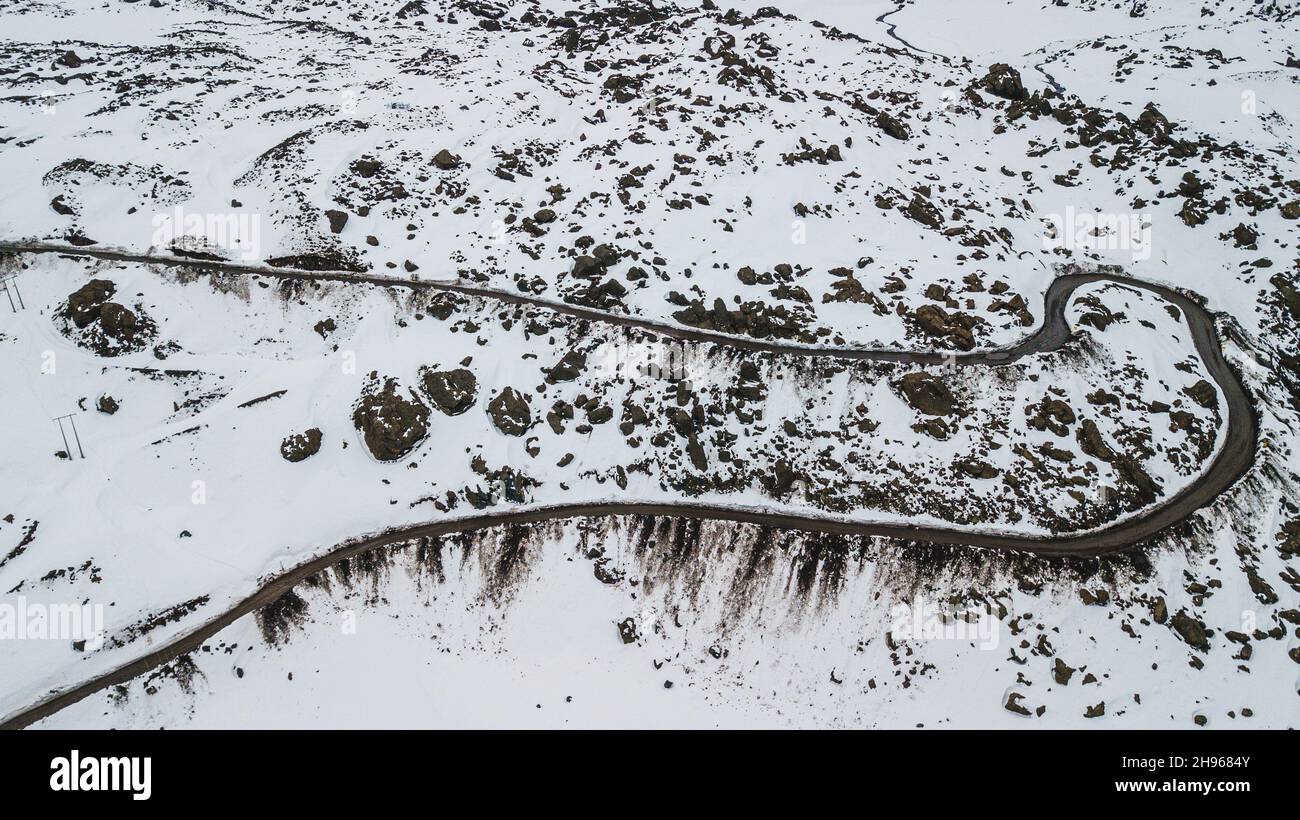 Aerial view of a mountainous landscape with a pathway and peaks covered ...