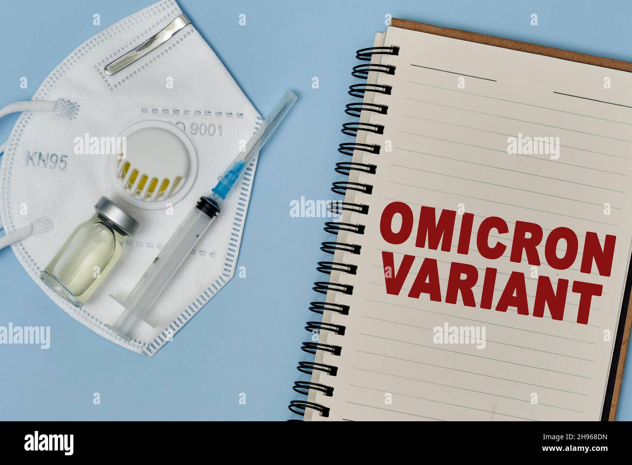 New omicron variant of Covid-19 text on notepad. Workspace or working ...