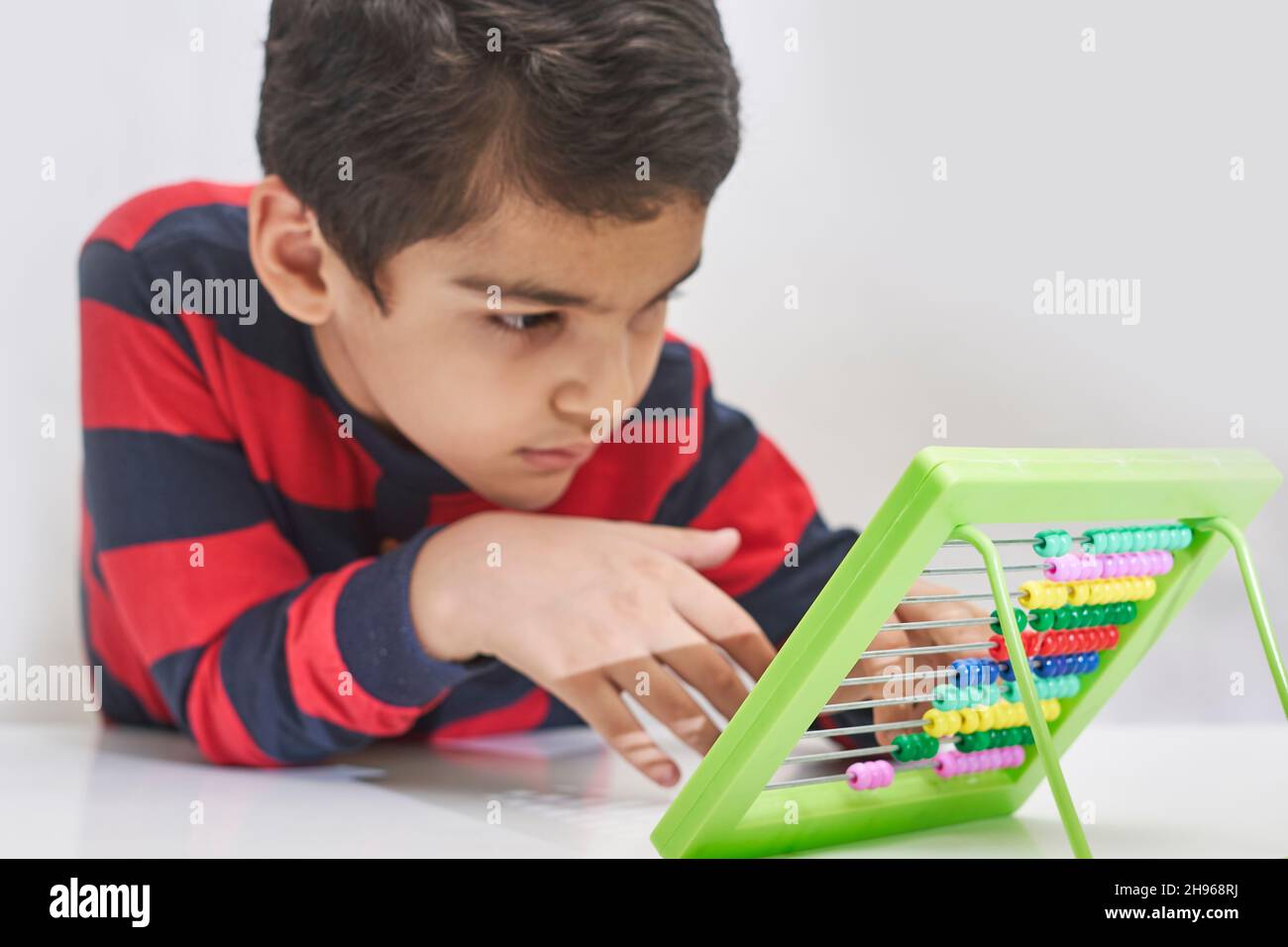 Schoolboy do mental math. Mental mathematics. 8 years old multiracial ...