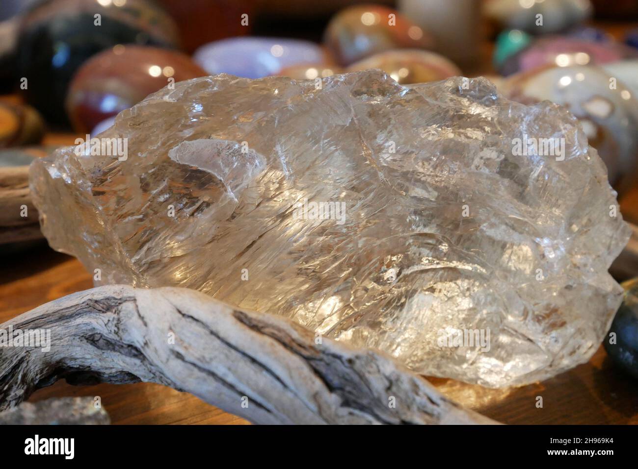 Closeup of a transparent crystalline mineral rock among other precious ...