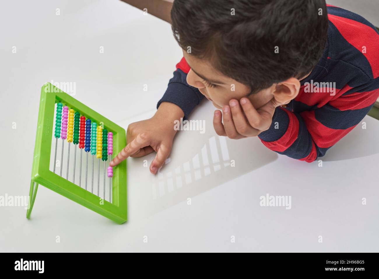 Schoolboy do mental math. Mental mathematics. 8 years old multiracial ...