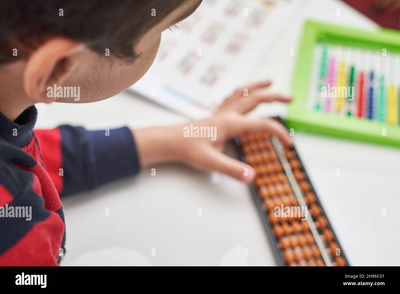 Schoolboy do mental math. Mental mathematics. 8 years old multiracial ...