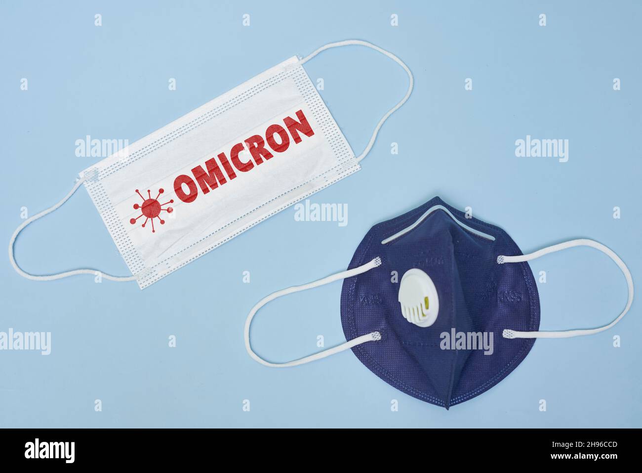 Female doctor holds a face mask with - Omicron variant text on it ...